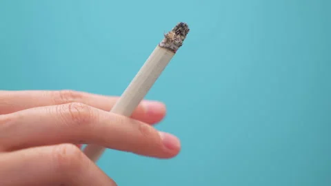 hand holding cigarette with grey ash on ... | Stock Video | Pond5