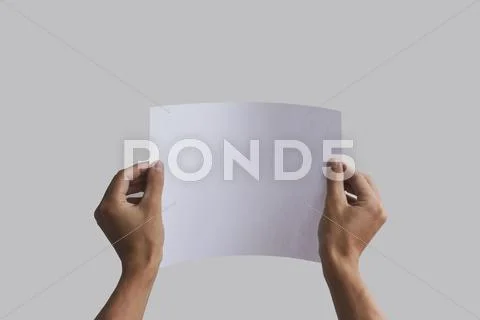 Hand holding curved A4 paper in the hand. Leaflet presentation ...