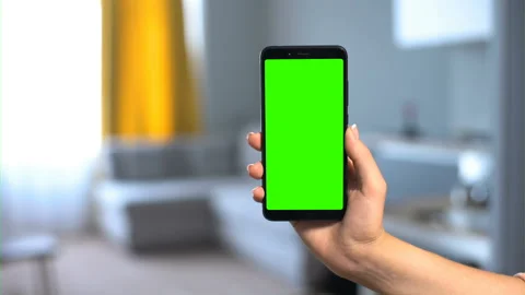 Hand holding phone on room interior back... | Stock Video | Pond5