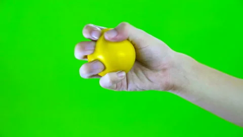 Hand holding a stress ball with green sc... | Stock Video | Pond5
