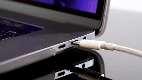 Hand inserting USB Type C wire into lapt... | Stock Video | Pond5