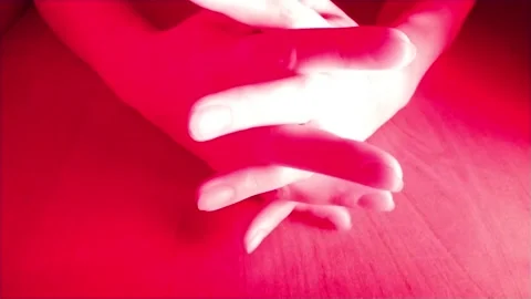 The hand lies motionless on the table in... | Stock Video | Pond5