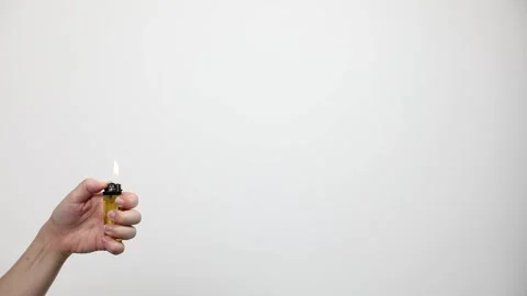 Hand lighting a lighter ignition. fire o... | Stock Video | Pond5