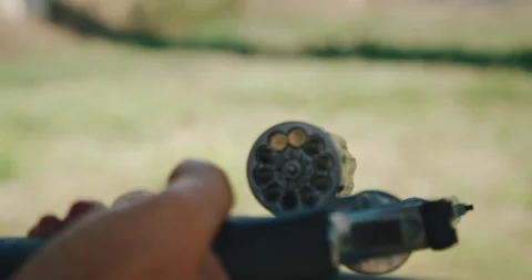 Hand loading bullet into revolver cylind... | Stock Video | Pond5
