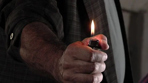 Hand of a Man Holding a Lighter in Dark ... | Stock Video | Pond5