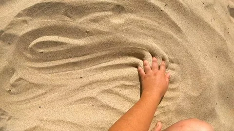 Hand movement on the sand surface, top v... | Stock Video | Pond5