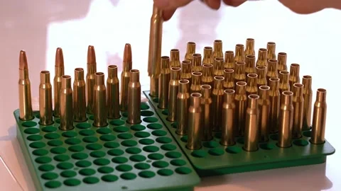 Hand picking up empty brass rifle casing... | Stock Video | Pond5