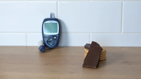 Hand picking sweets on the kitchen table... | Stock Video | Pond5