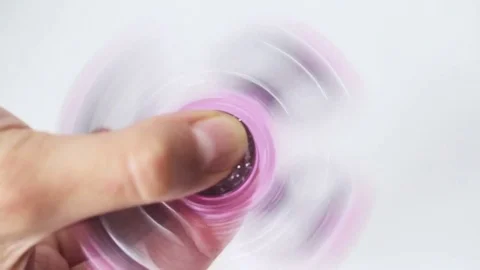 hand playing with spinning fidget spinne... | Stock Video | Pond5