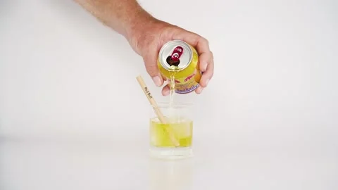 Hand pouring Red Bull energy drink to gl... | Stock Video | Pond5
