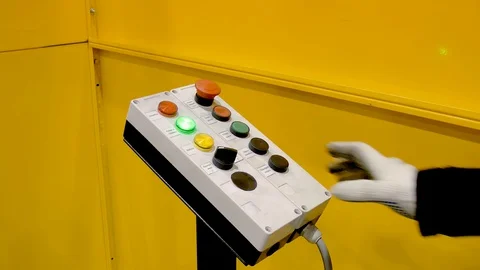 Hand presses a large button on a yellow ... | Stock Video | Pond5