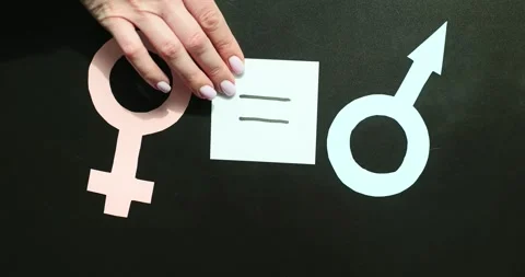 Hand puts equation sign between female a... | Stock Video | Pond5