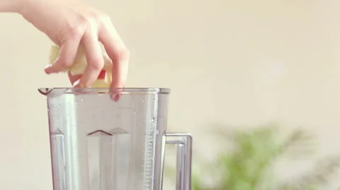 Hand putting fruits in blender | Stock Video | Pond5