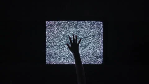 A Hand Reaching up to a Static Tv in a D... | Stock Video | Pond5