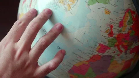 Hand rotating globe to find American con... | Stock Video | Pond5
