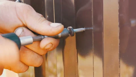 Hand screwdriver and screws cut into the... | Stock Video | Pond5