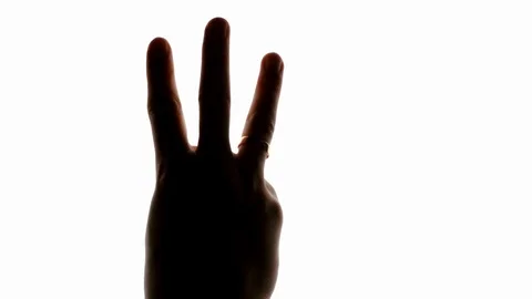 Hand showing three point sign on a white... | Stock Video | Pond5