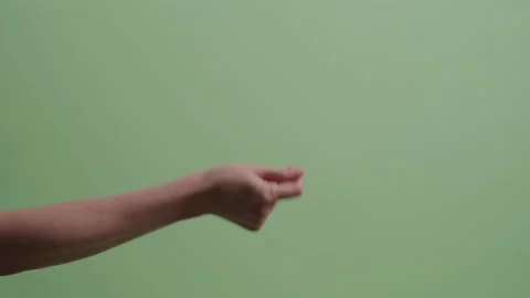 Hand Snap in Front of Green Backdrop | Stock Video | Pond5