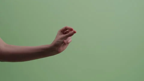 Hand Snaps in Front of Green Backdrop | Stock Video | Pond5