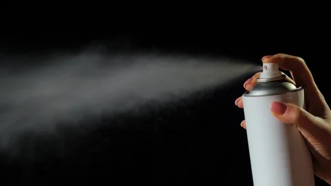 Hand with a spray can sprays it on a bla... | Stock Video | Pond5