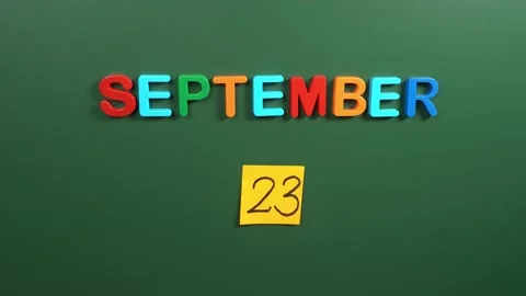 Hand sticking a sticker 23 September cal... | Stock Video | Pond5