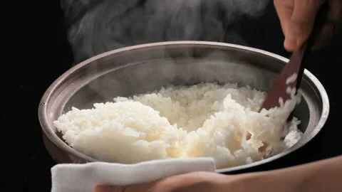 Hand stirring cooked rice | Stock Video | Pond5