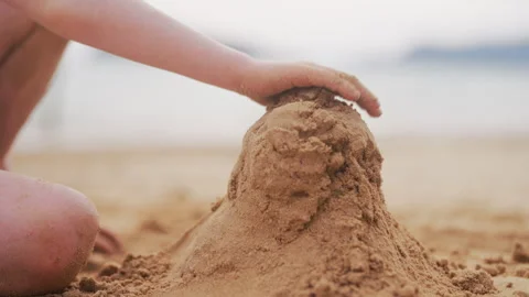 Hand Tapping On A Pile Of Sand At A Beac... | Stock Video | Pond5