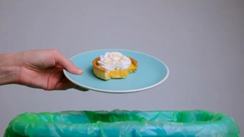 The hand throws the bitten cake into the... | Stock Video | Pond5
