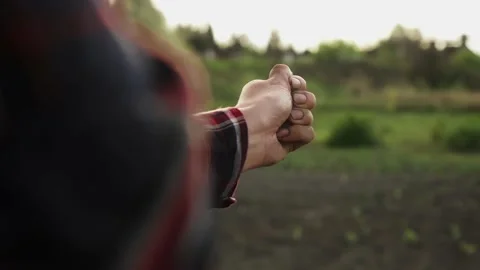 the hand throws the earth the dust flies... | Stock Video | Pond5