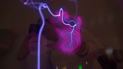Hand touching plasma ball with blue viol... | Stock Video | Pond5