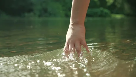Hand touching water stream river or lake... | Stock Video | Pond5