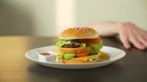 Hand Under Table Trying to Grab a Plate ... | Stock Video | Pond5