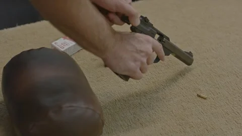 Hand unloading pistol by pulling back th... | Stock Video | Pond5