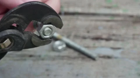 a hand unwinds a bolt from a nut holding... | Stock Video | Pond5