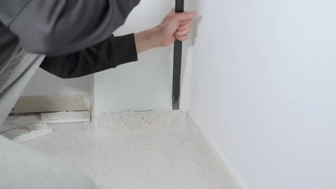 Hand of white man removing tile skirting... | Stock Video | Pond5
