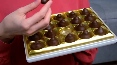 Hand of woman is taking a chocolate cand... | Stock Video | Pond5