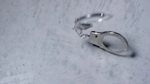 Handcuffs falling on concrete floor | Stock Video | Pond5