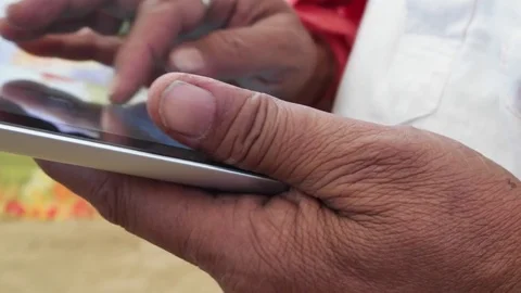 Handheld Indian man busy on a touchscree... | Stock Video | Pond5
