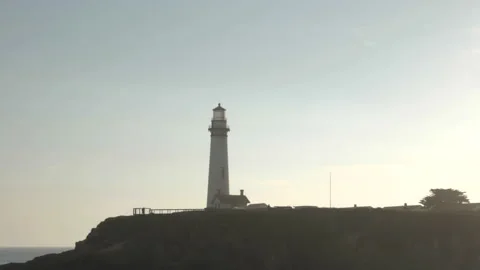 Handheld of lighthouse silhouette on sea... | Stock Video | Pond5