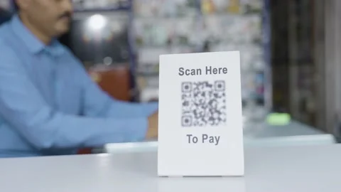 Handheld shot of scan here to pay sign b... | Stock Video | Pond5