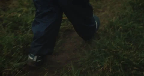 A HANDHELD TRACKING SHOT of a young chil... | Stock Video | Pond5