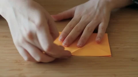 Hands of artistic woman folding a yellow... | Stock Video | Pond5