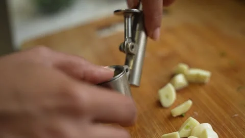 Hands of chef putting garlic cloves in g... | Stock Video | Pond5