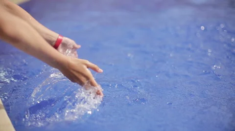 Hands of child splashing water in the po... | Stock Video | Pond5