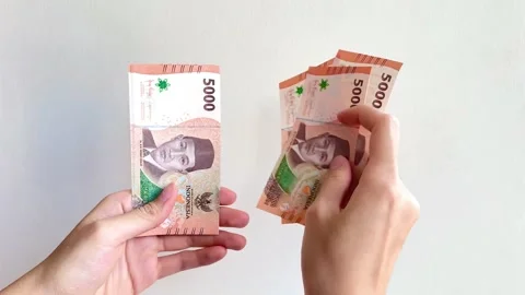 Hands counting IDR 5K isolated on white ... | Stock Video | Pond5