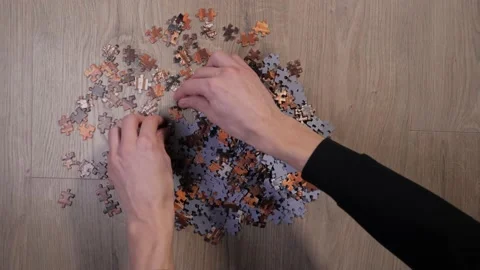 Hands flip puzzle pieces up, top down ti... | Stock Video | Pond5