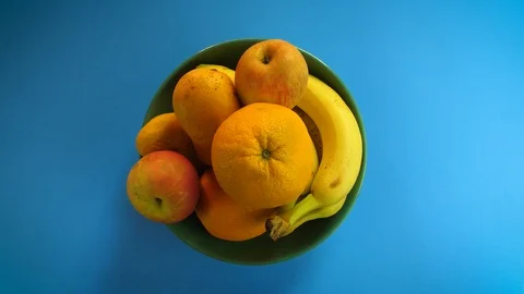 Hands grab fruit out of fruitbowl. This ... | Stock Video | Pond5