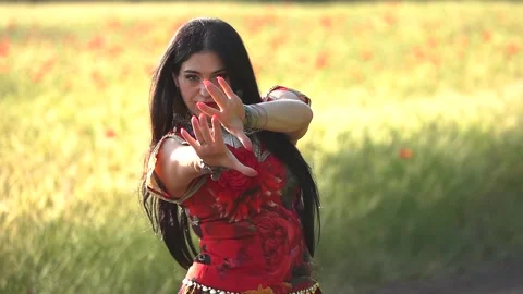 Hands. Gypsy girl in a field of poppies ... | Stock Video | Pond5