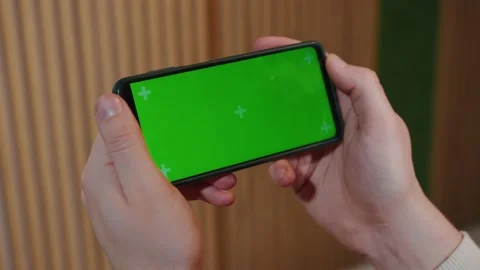 Hands hold the phone in a horizontal pos... | Stock Video | Pond5