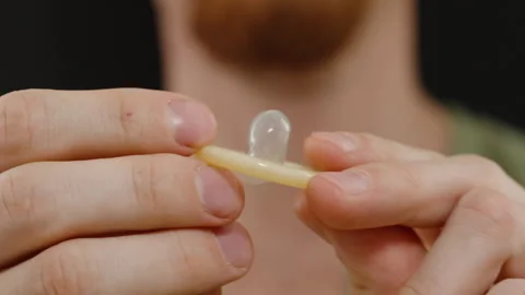 Hands Holding a Condom Close-Up with Foc... | Stock Video | Pond5